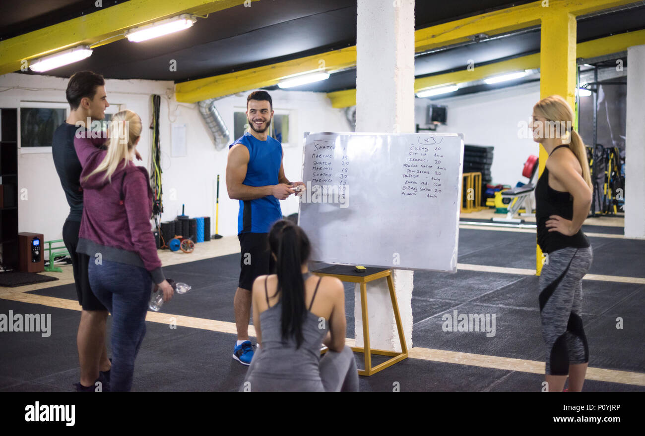 Training course.group of young athletes getting instructions from ...