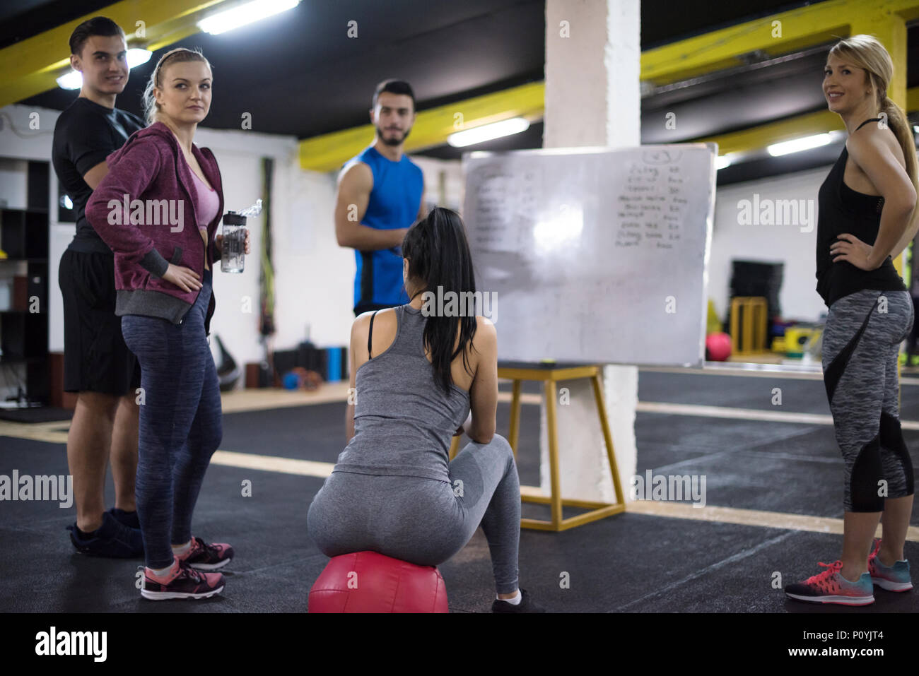Training course.group of young athletes getting instructions from ...