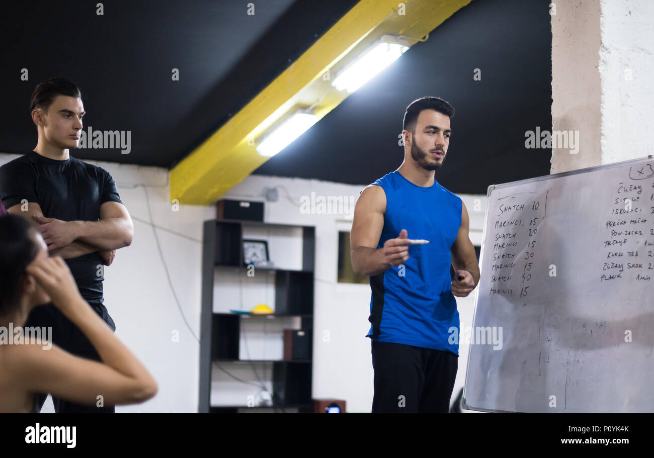 Training course.group of young athletes getting instructions from ...
