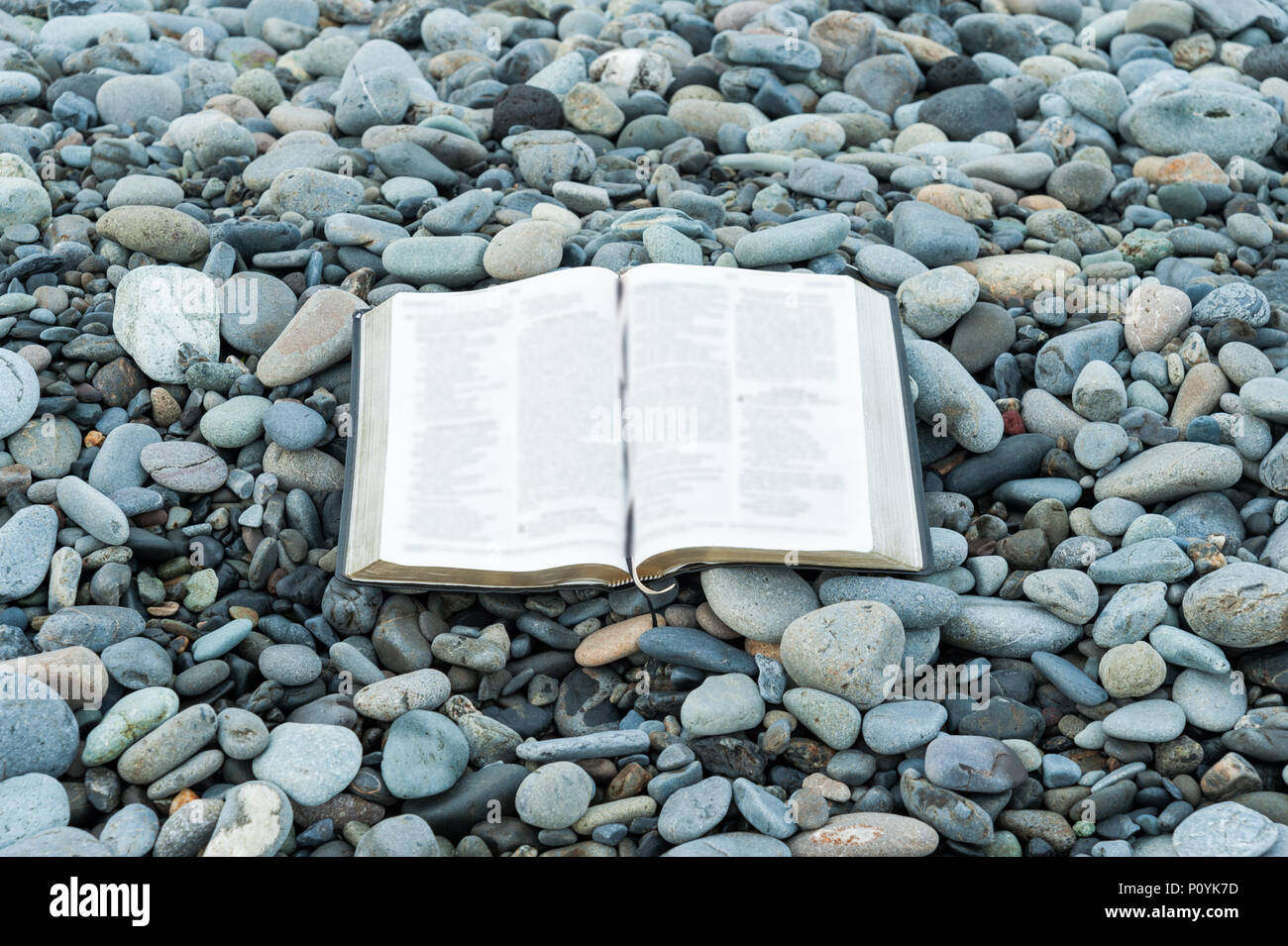 Open Bible on top of small stones. Copy space Stock Photo - Alamy