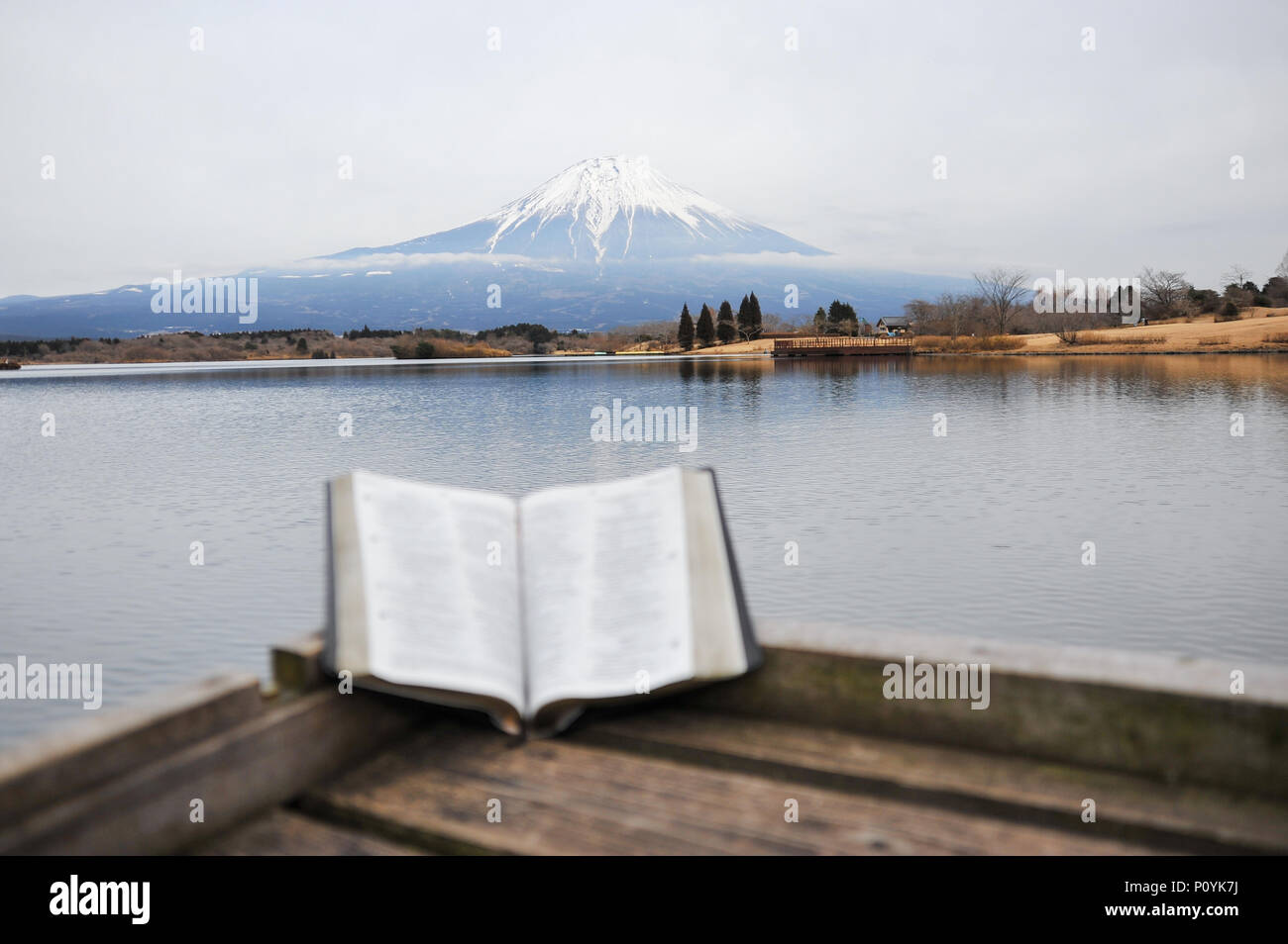 Bible open on a wooden bridge in front of the beautiful Mount Fuji on a ...