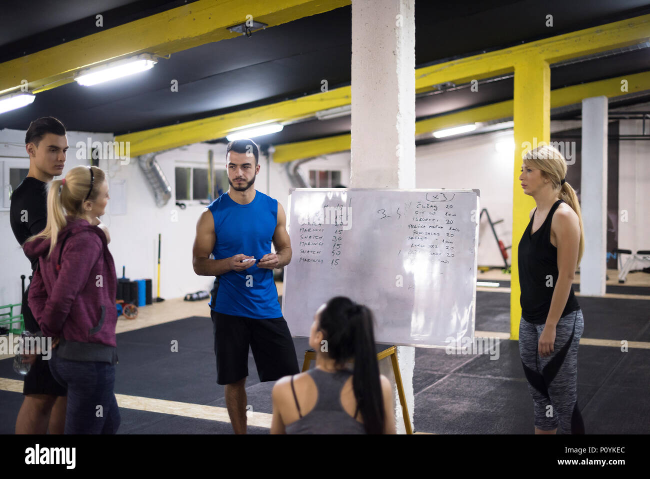 Training course.group of young athletes getting instructions from ...