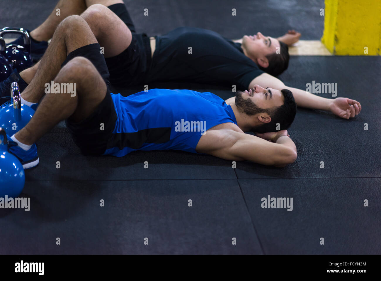 a group of young athletes lying on the floor and relaxing after ...