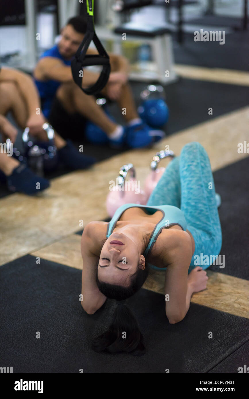 young athlete woman lying on the floor and relaxing before a hard ...