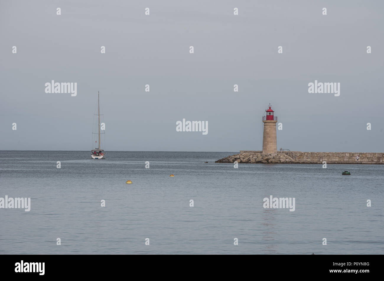 Lighthouse and Sailboat - View to ocean Stock Photo - Alamy