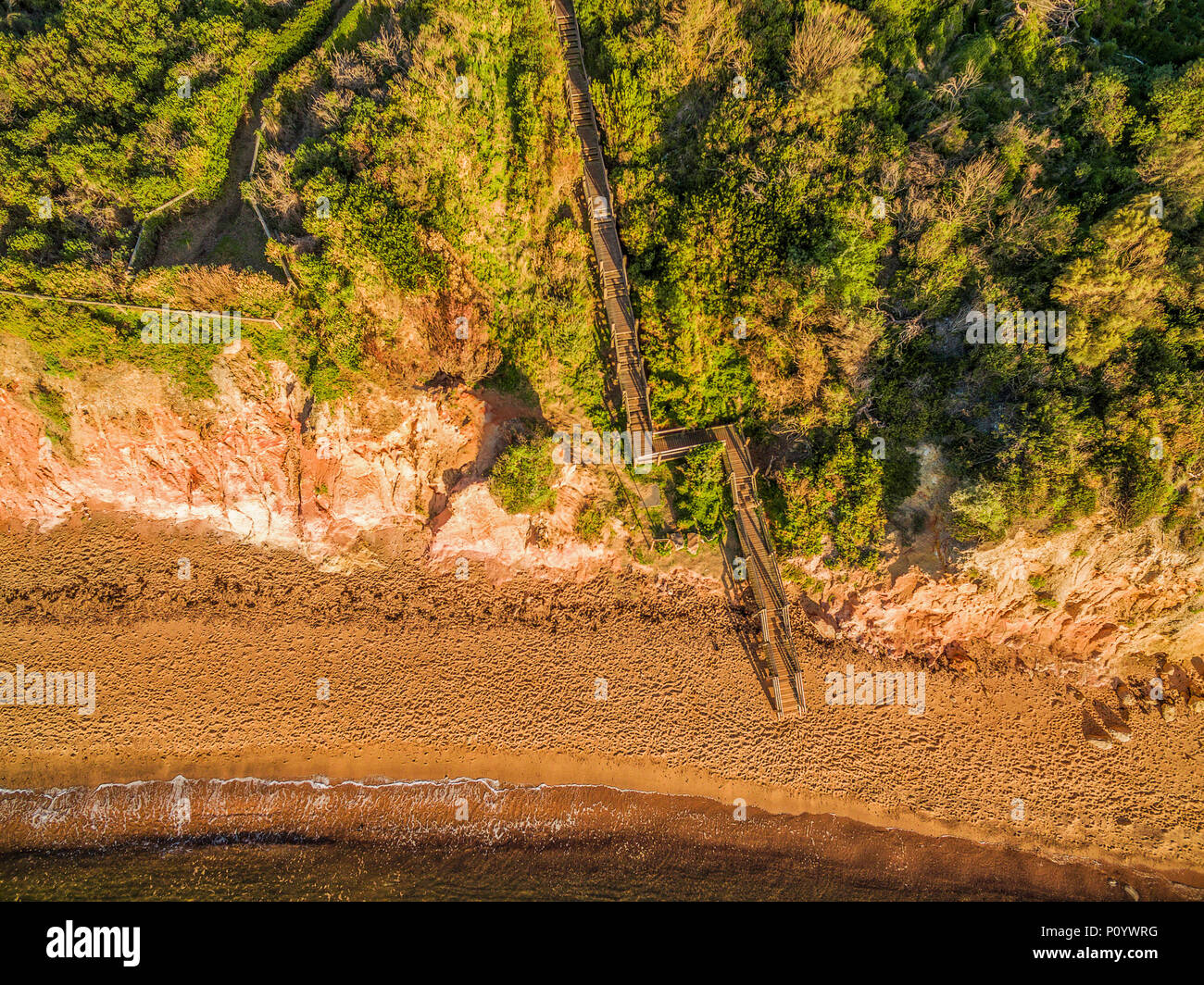 Aerial view of wooden staircase leading to a beautiful ocean bay and ...
