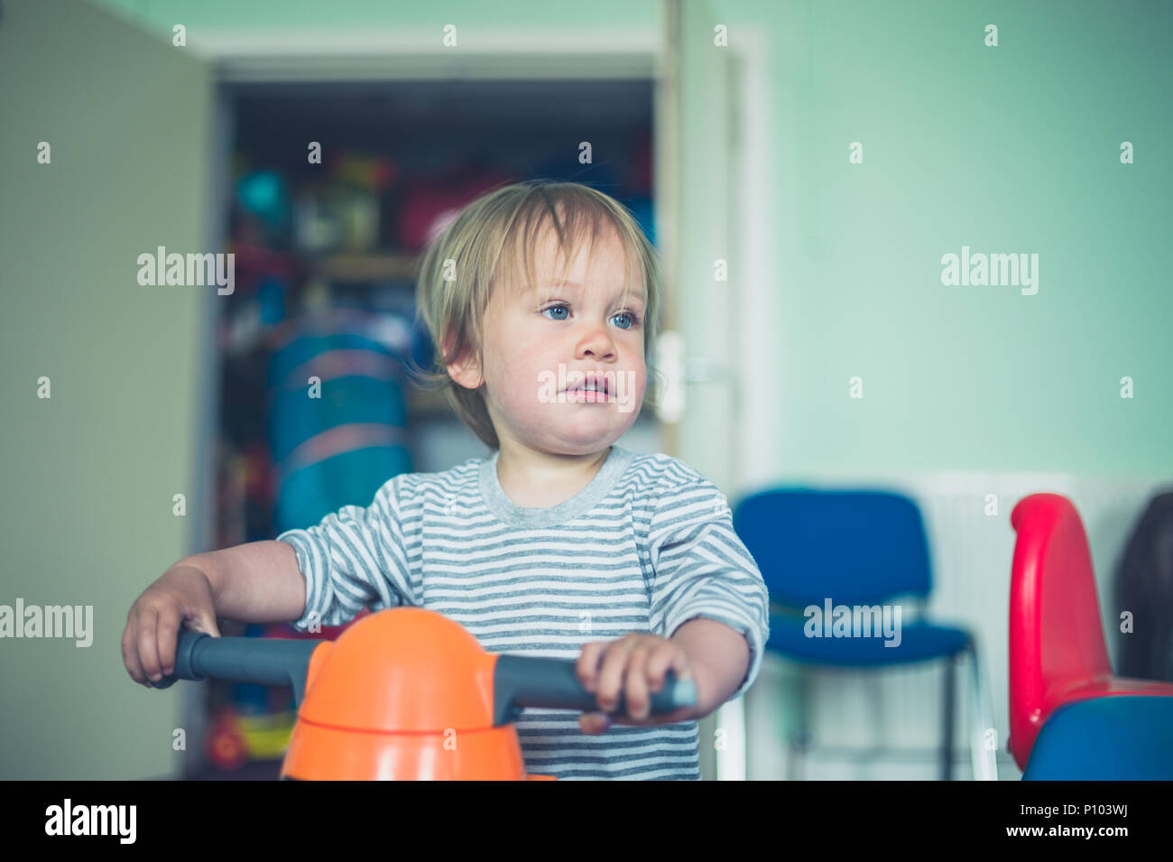 Happy child riding tricycle hi-res stock photography and images - Alamy