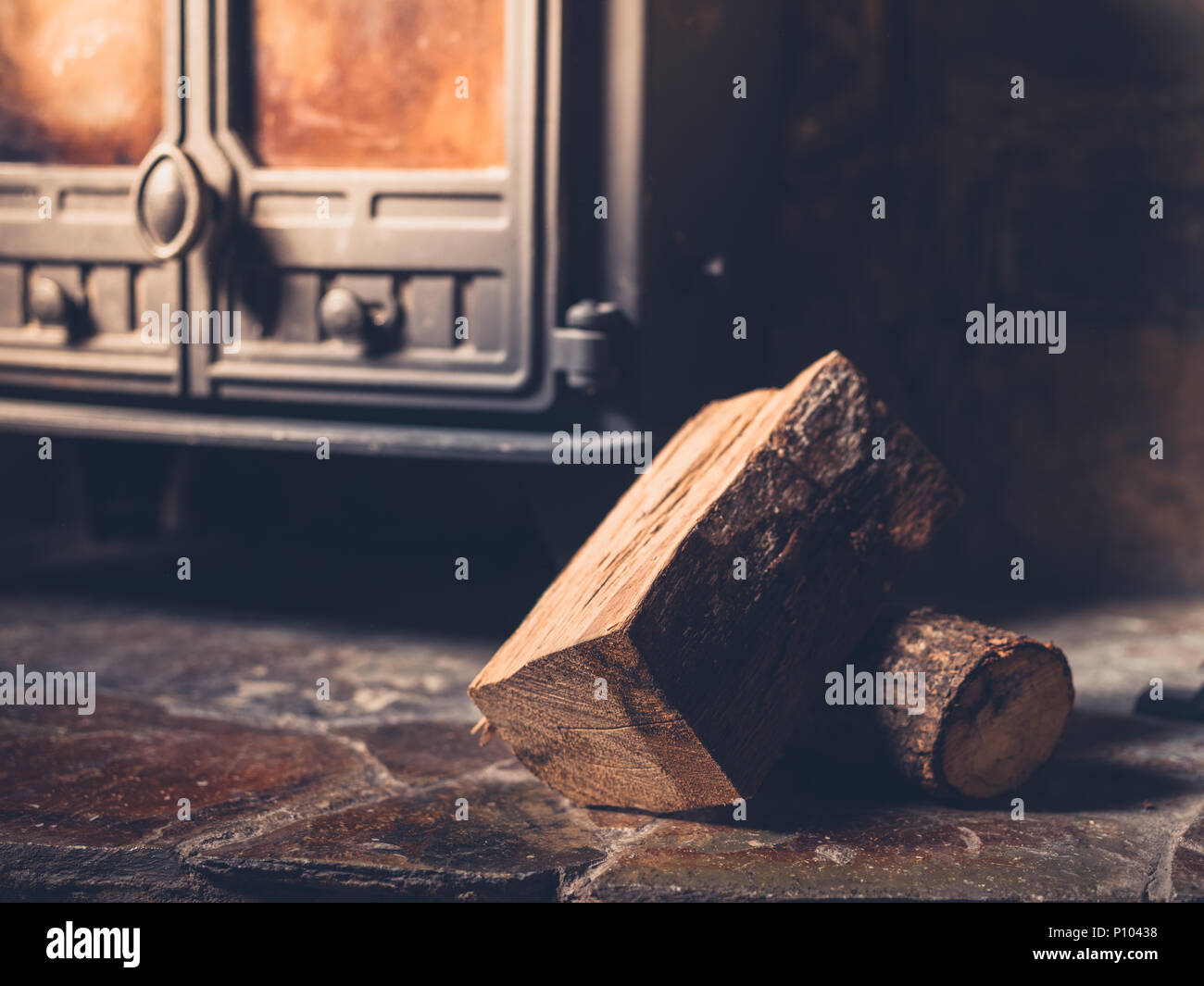 A small pile of logs by a wood burner Stock Photo - Alamy
