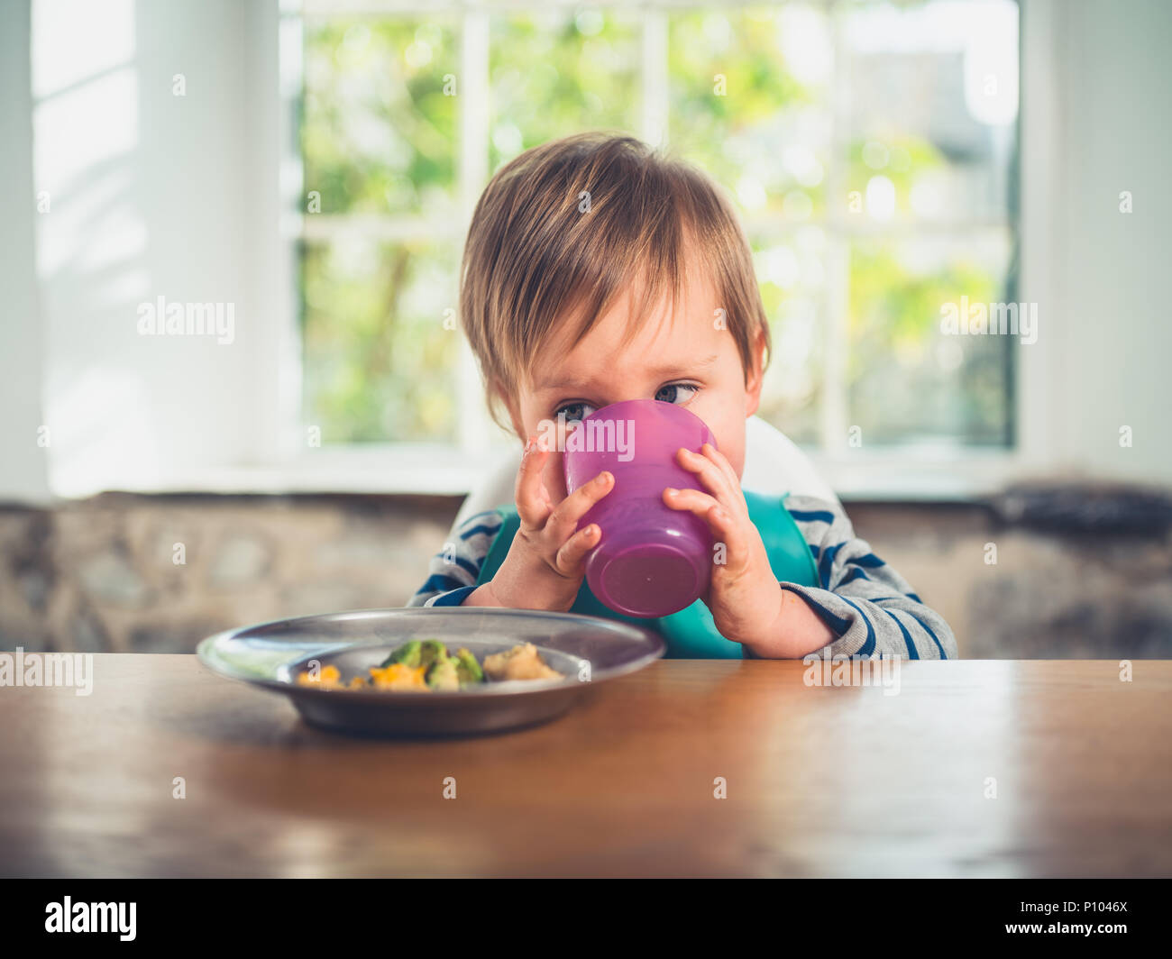 Young boy drinking from beaker hi-res stock photography and images - Alamy