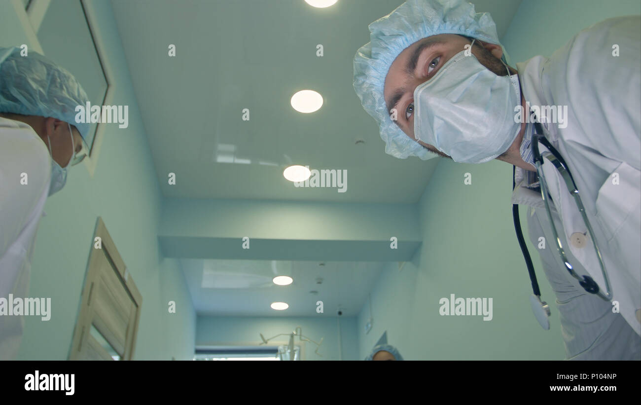 Surgeons looking down at patient getting ready for urgent surgery Stock ...