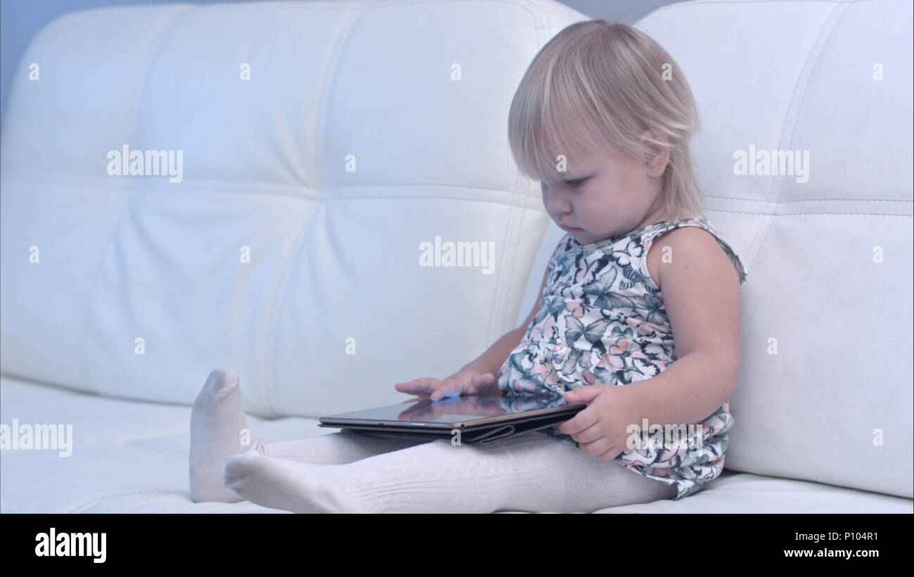 Baby using digital tablet at home Stock Photo - Alamy