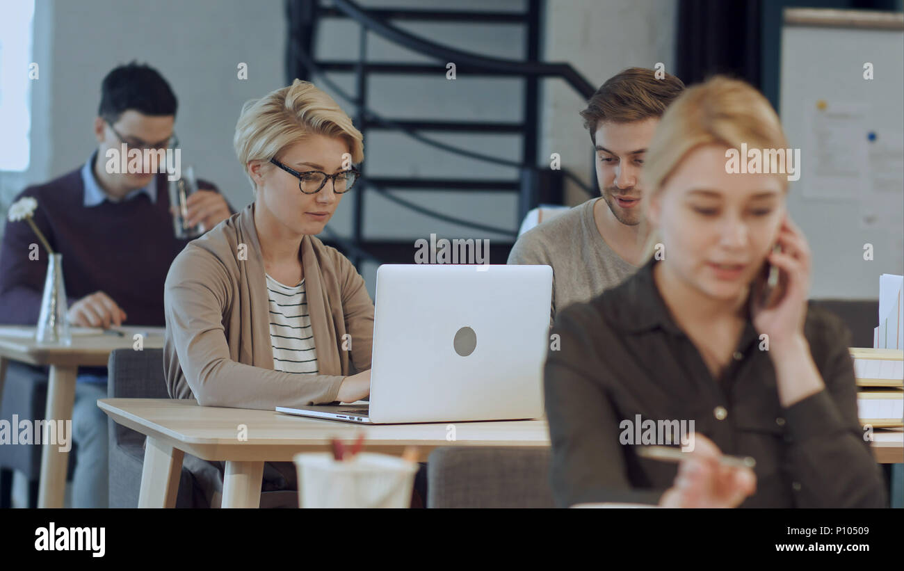 Busy design office with workers at desks Stock Photo - Alamy
