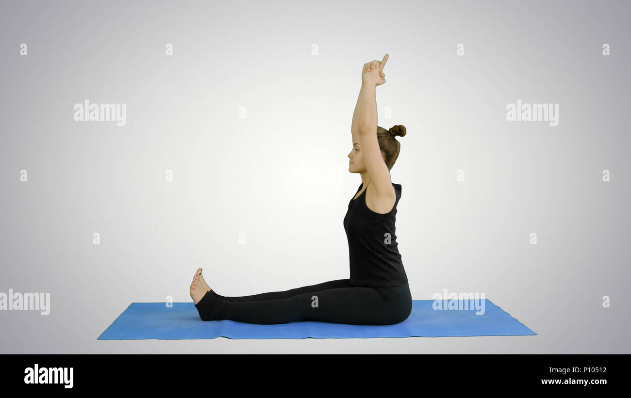 Young girl doing stretching exercises on white background Stock Photo ...