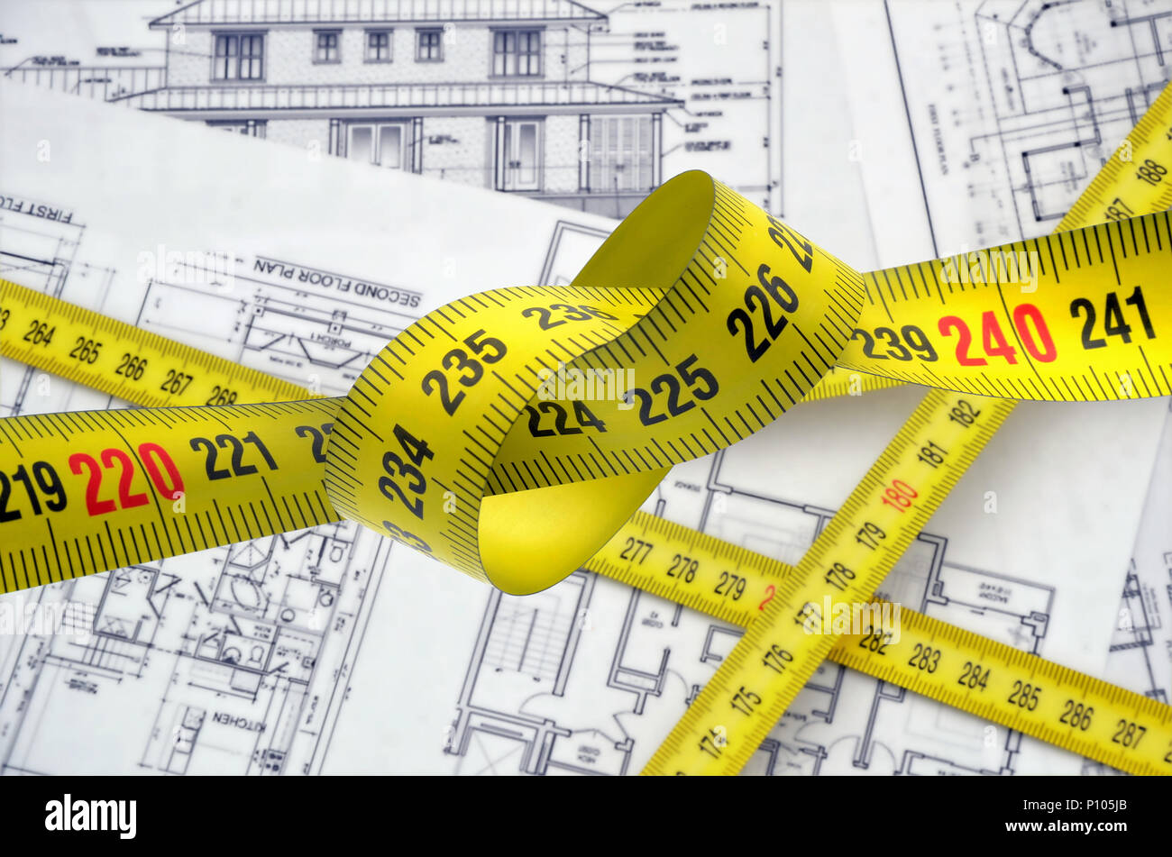 tangled tape measure with construction plan Stock Photo - Alamy