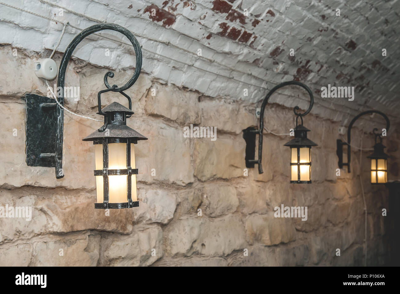 Old electric lights in a stone arch Stock Photo - Alamy
