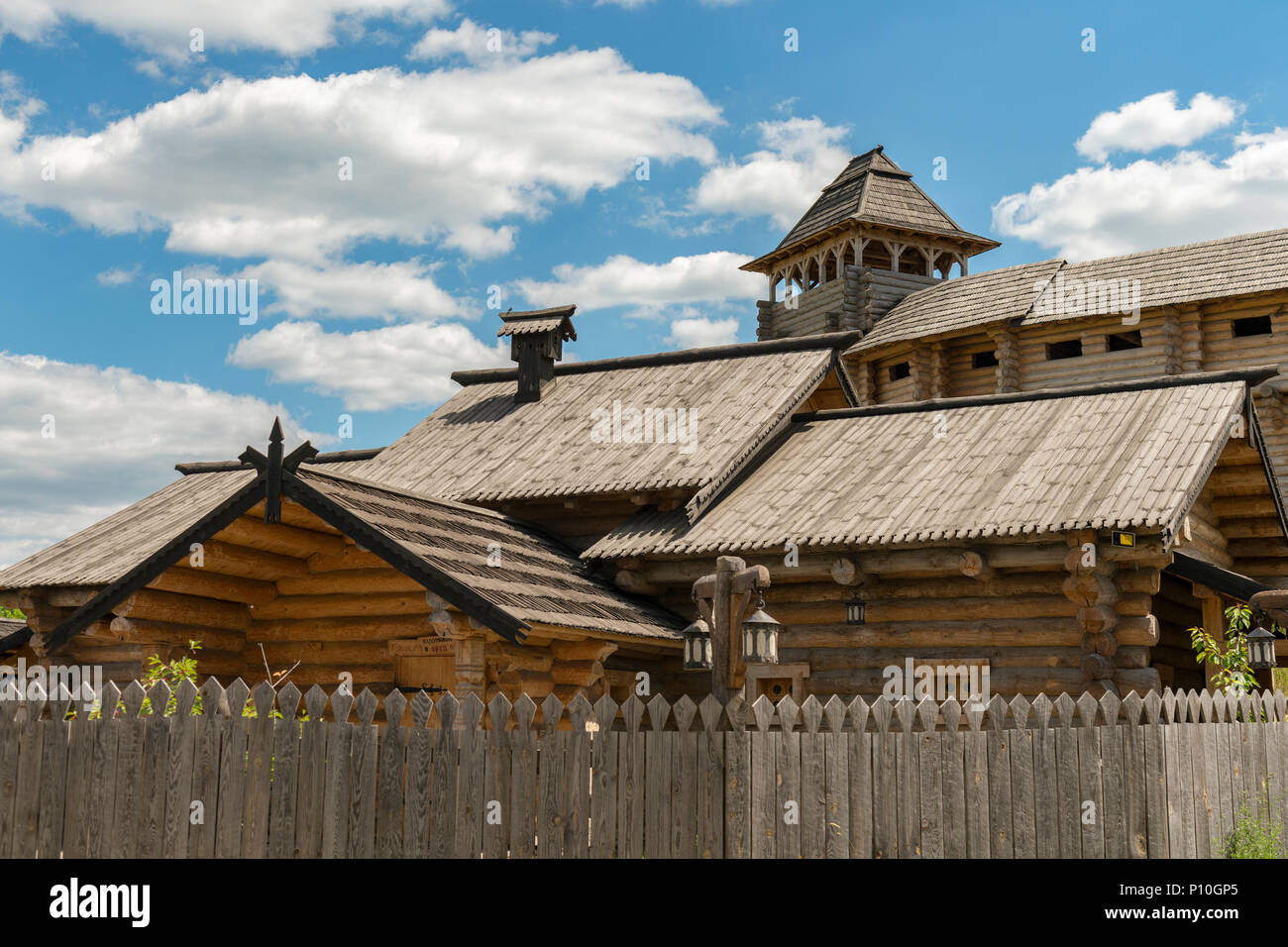 Wooden fortress with the walls against a blue sky with white clouds ...