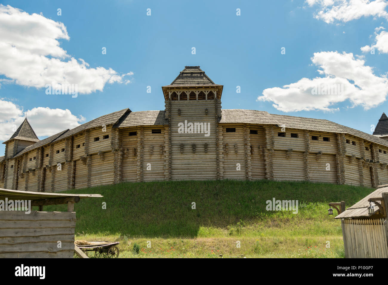 Wooden fortress with the walls against a blue sky with white clouds ...