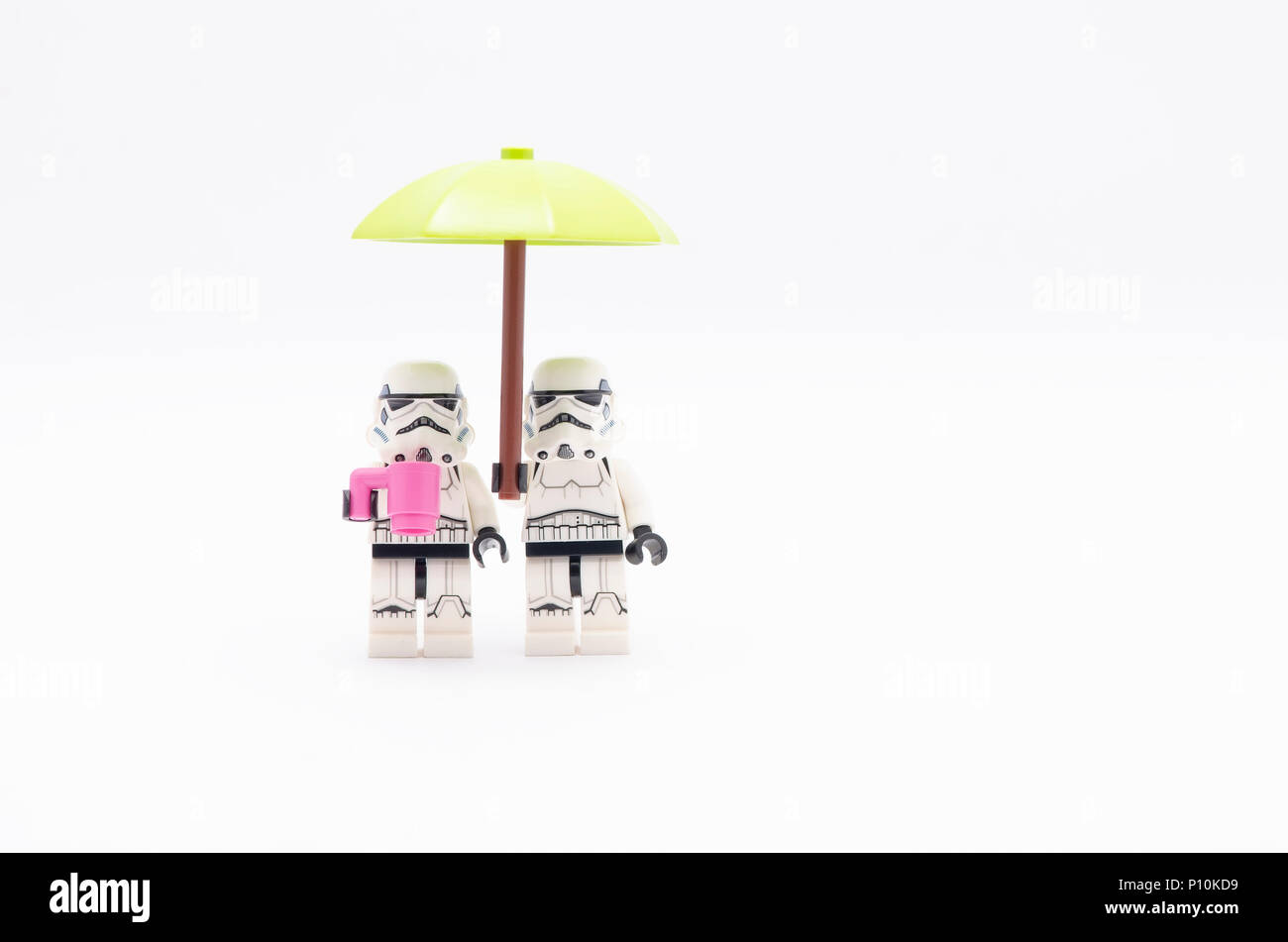 mini figure of storm trooper having a drink with one of them holding ...