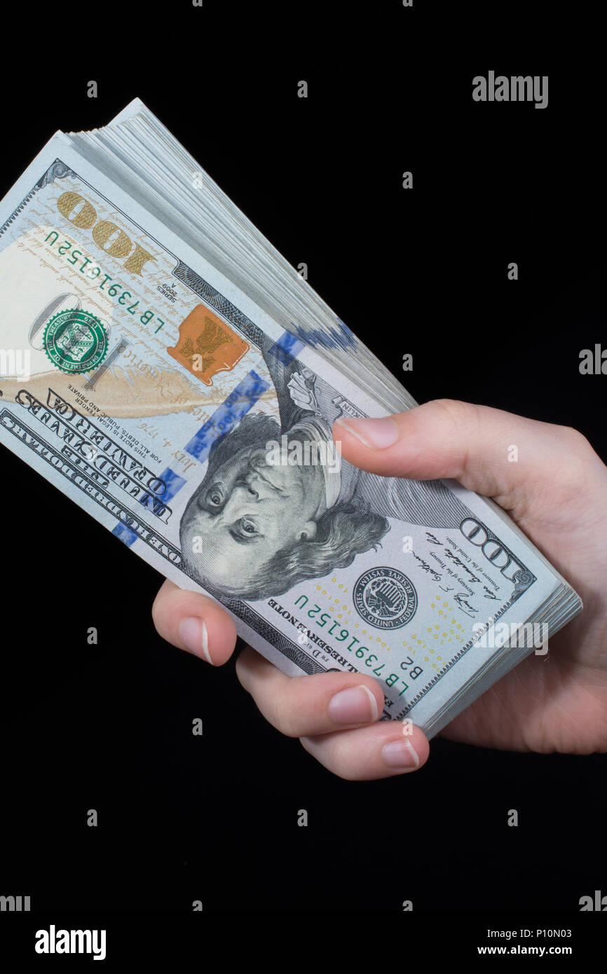 Hand holding American dollar banknotes isolated on white background ...