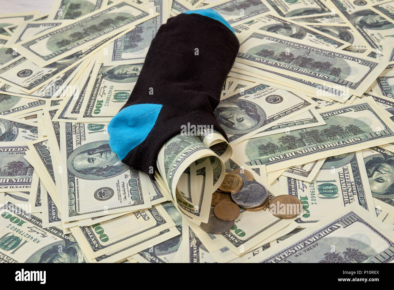Sock with money and coins. Heap of dollars. Saving money in a sock ...