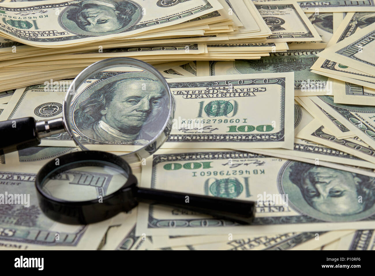 Heap of dollars and magnifiers. Concept close-up money dollars and ...