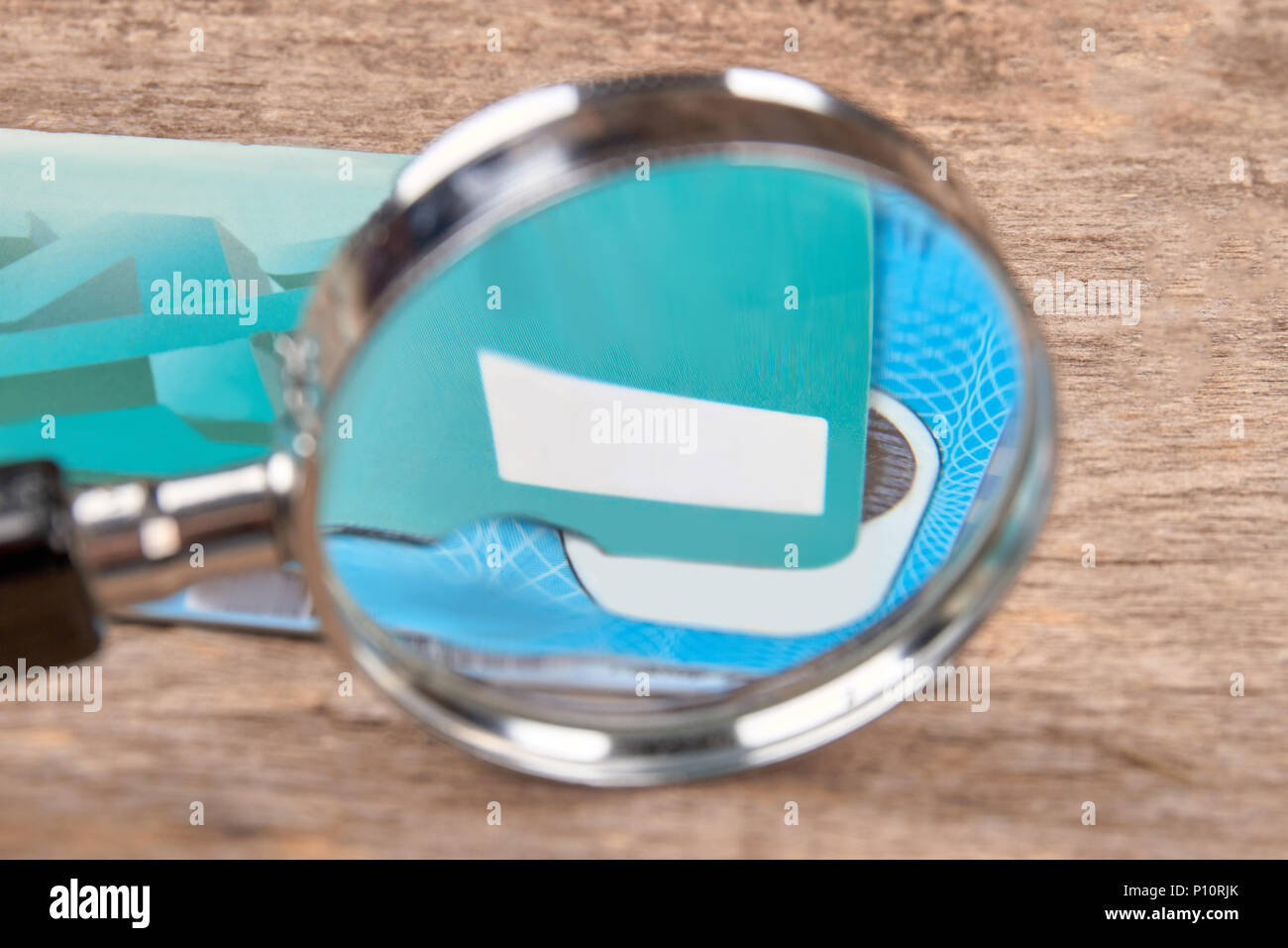 Cards and magnifying glass. Close up. Wooden desk background Stock ...