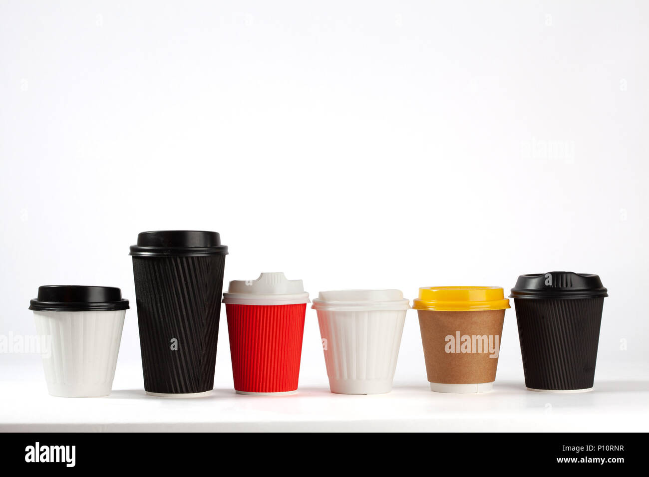 Six various recycled coffee cups on white background with copy space ...