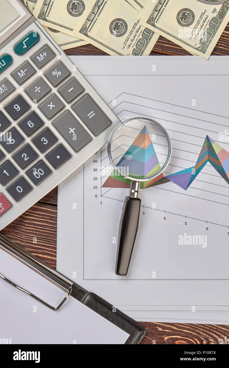 Finance and statistic concept. Magnifying glass, diagram statistics ...
