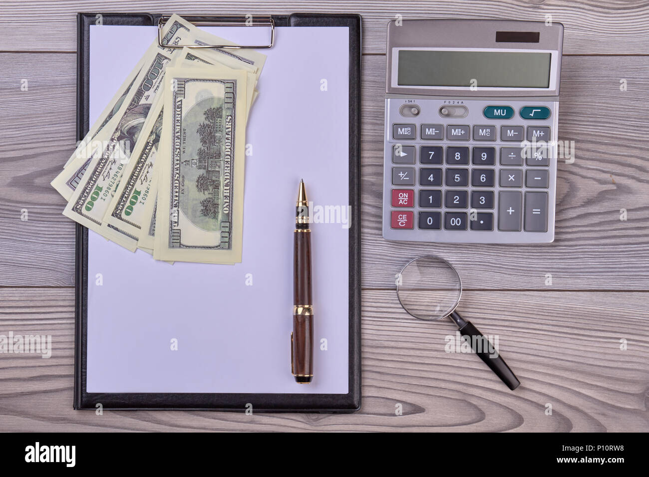 Notepad, money, calculator and wood table wiht copy space. clipboard ...