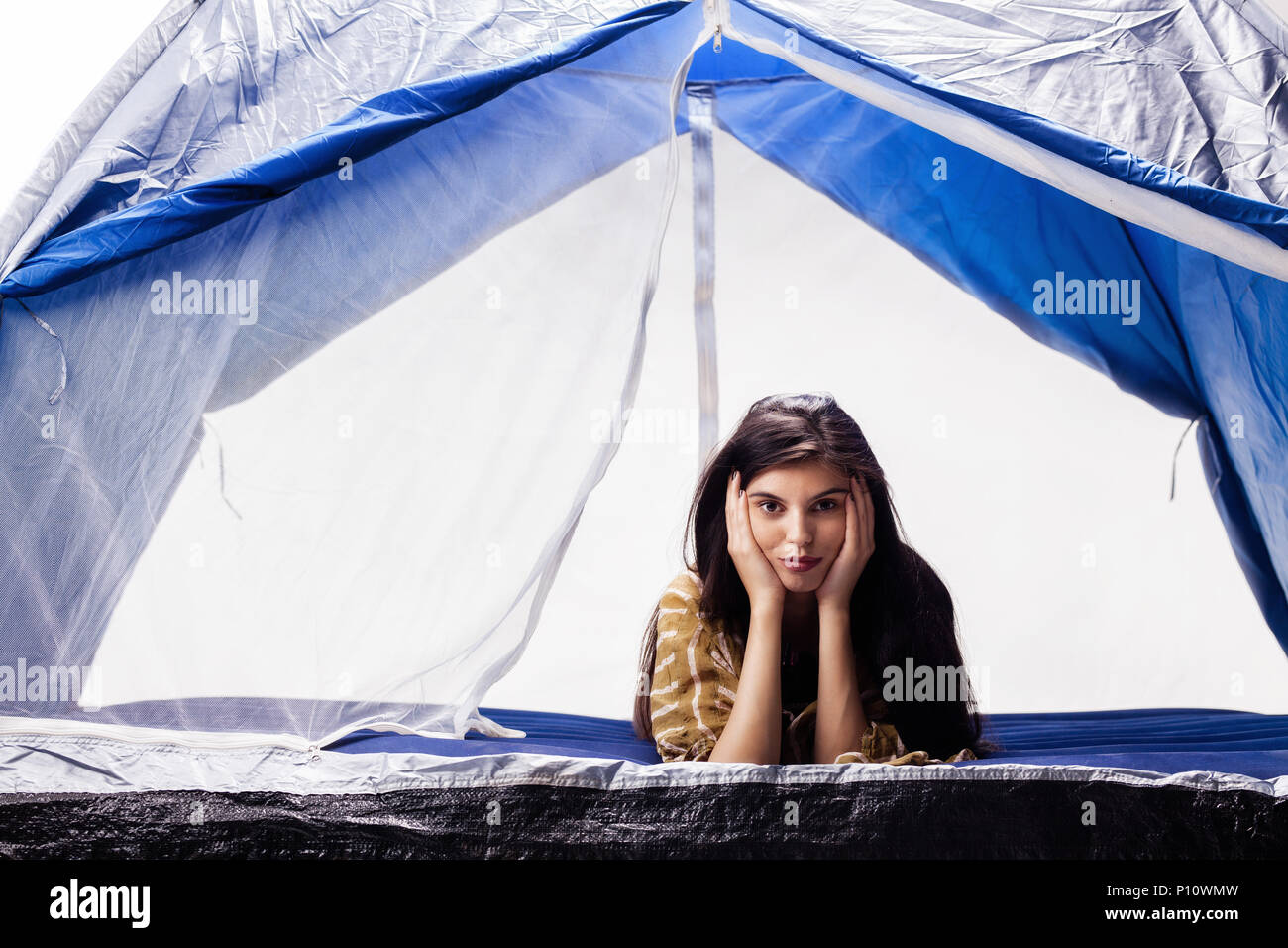 girl lying inside a large tent, studio shot Stock Photo - Alamy