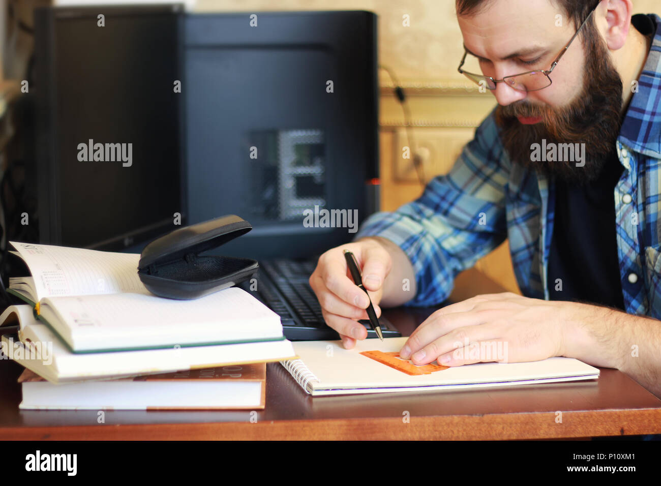 male work with computer and pen write Stock Photo - Alamy