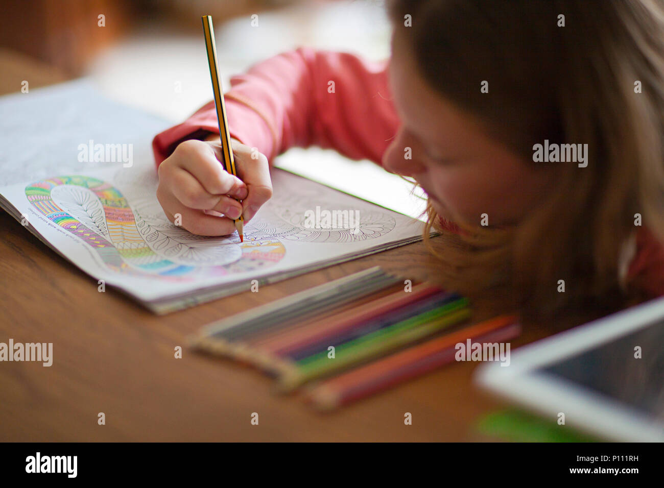 Young girl colouring in Stock Photo - Alamy