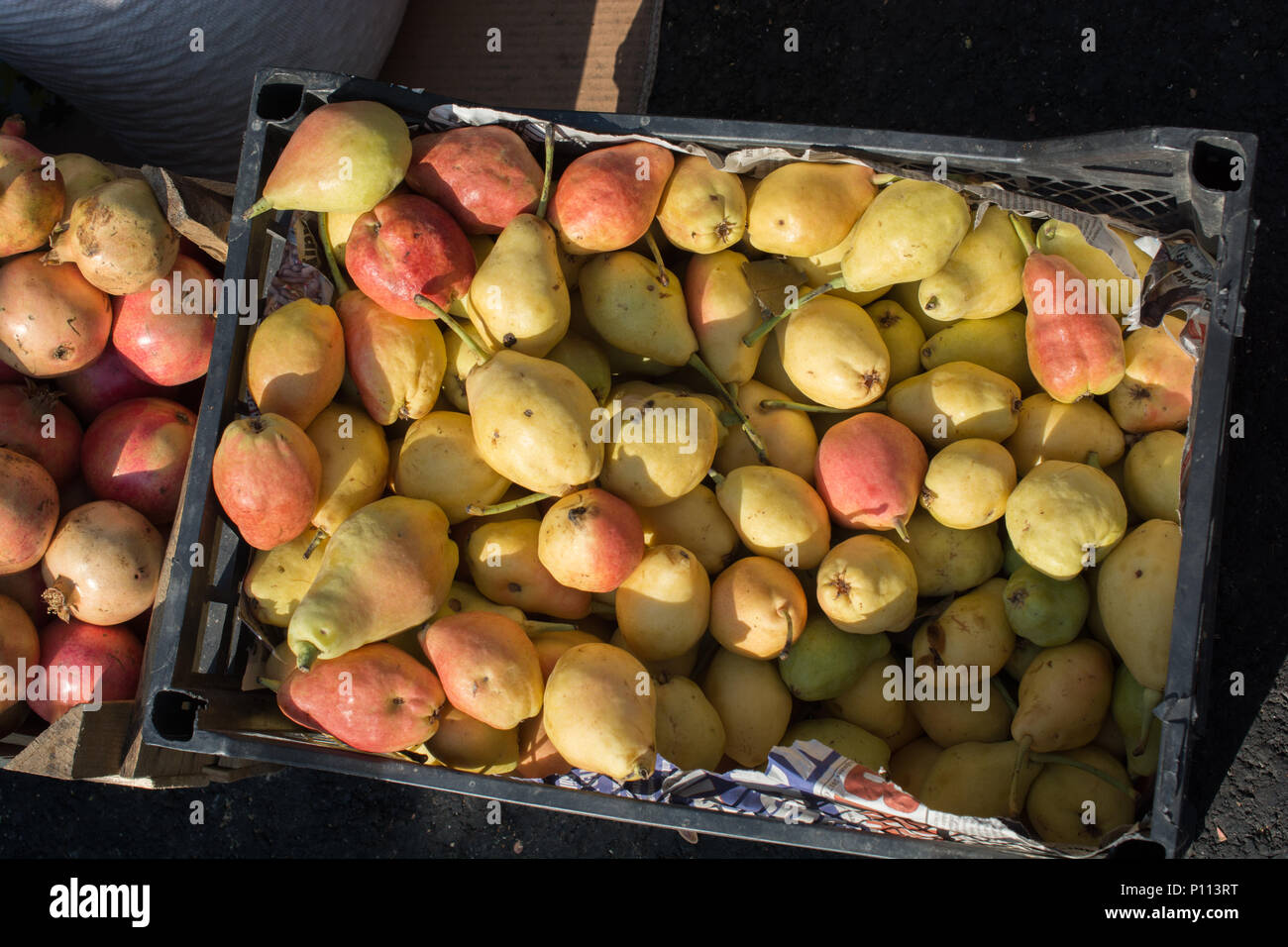 Wooden crate full of organic pears in view Stock Photo - Alamy