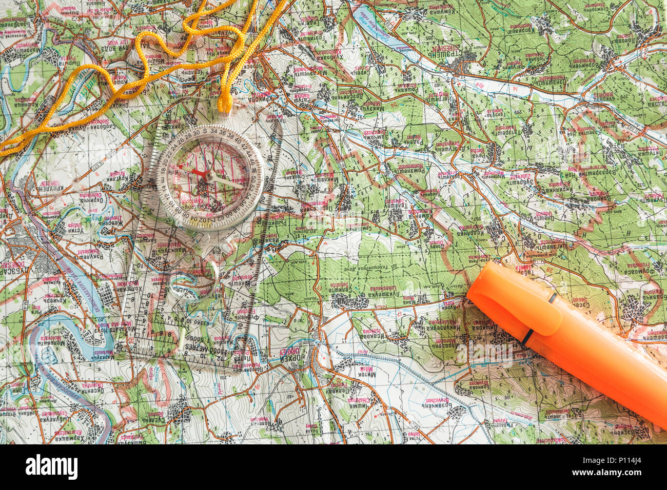 A compass and an orange marker on a map Stock Photo - Alamy