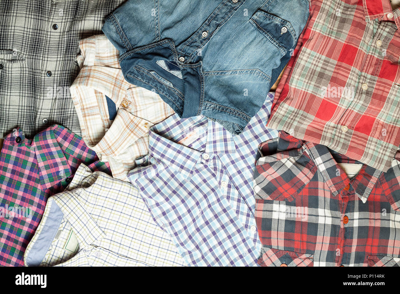 Lot of different checkered shirts. Cloth wallpaper Stock Photo - Alamy