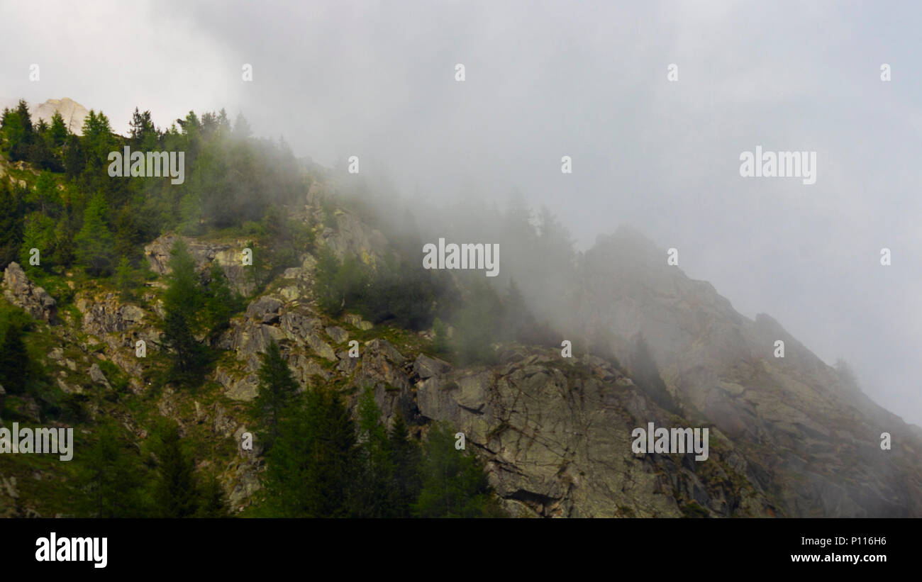 Awesome peaks mountains in the middle of mist Stock Photo - Alamy