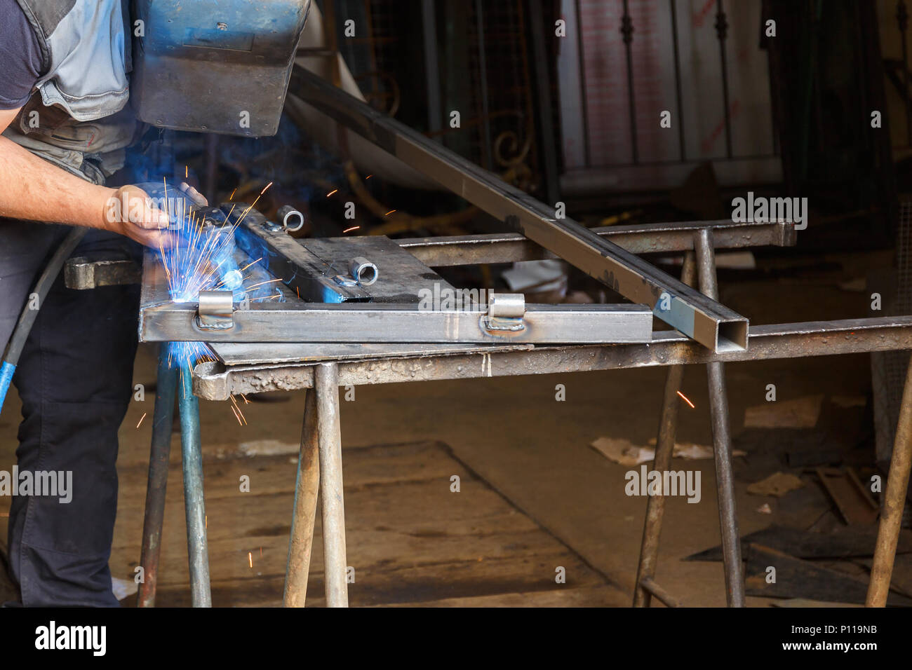 Man who repair by welding in a workshop Stock Photo - Alamy