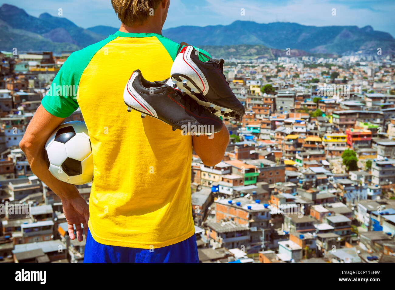 Brazilian football player standing in Brazil colors kit holding soccer ...
