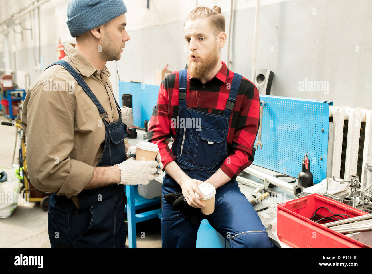 Car Mechanics Talking On Break Stock Photo - Alamy