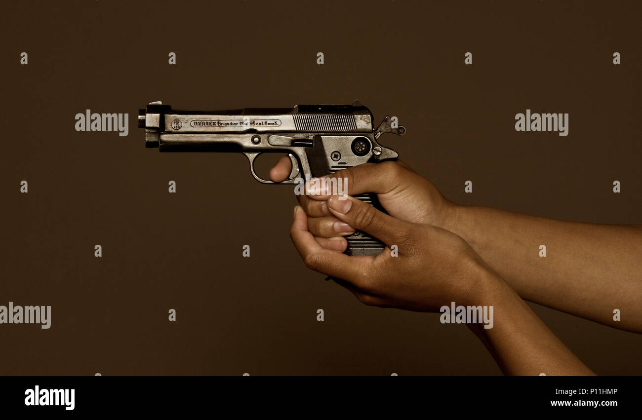 Man holding 9mm gun hi-res stock photography and images - Alamy
