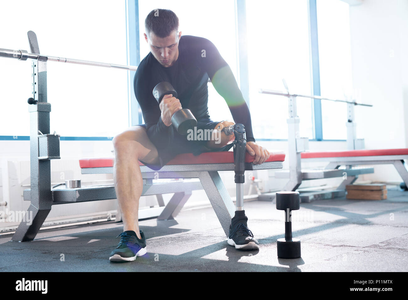 Muscular man with dumbbell Stock Photo - Alamy