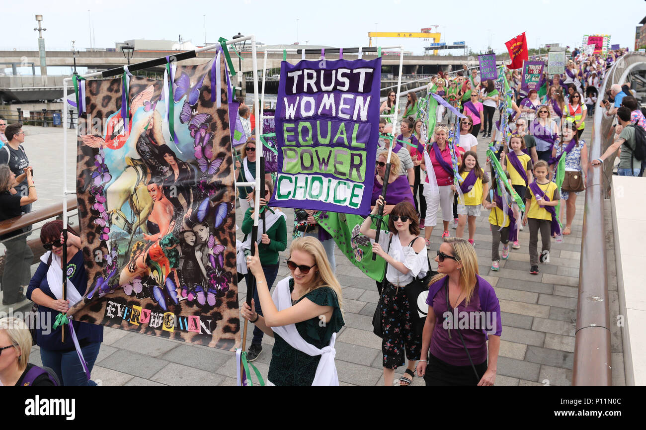 Women take part in the Processions' artwork march, in Belfast, as they ...