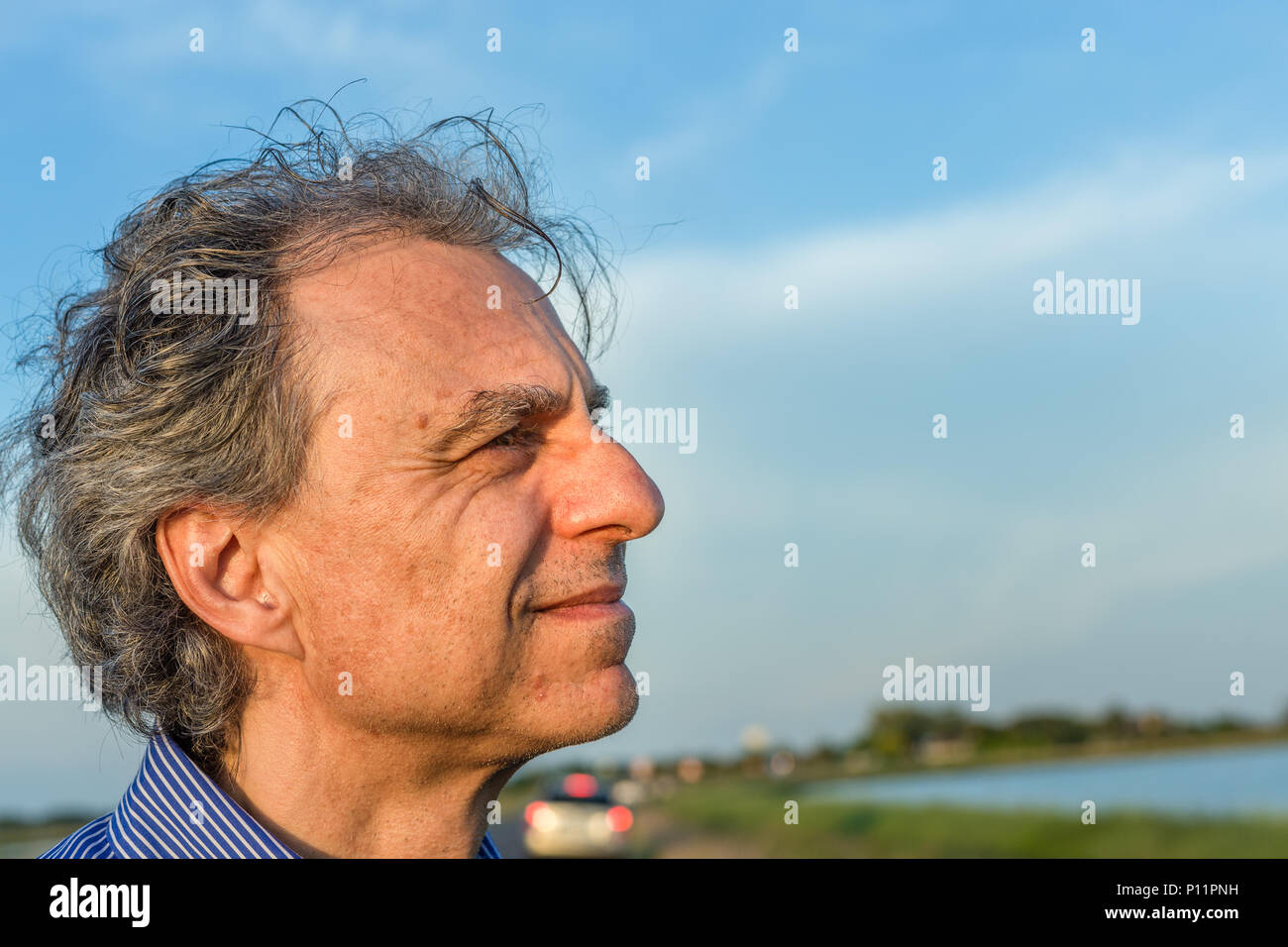 mature man with tanned and aged sagging skin with wrinkles and spots ...