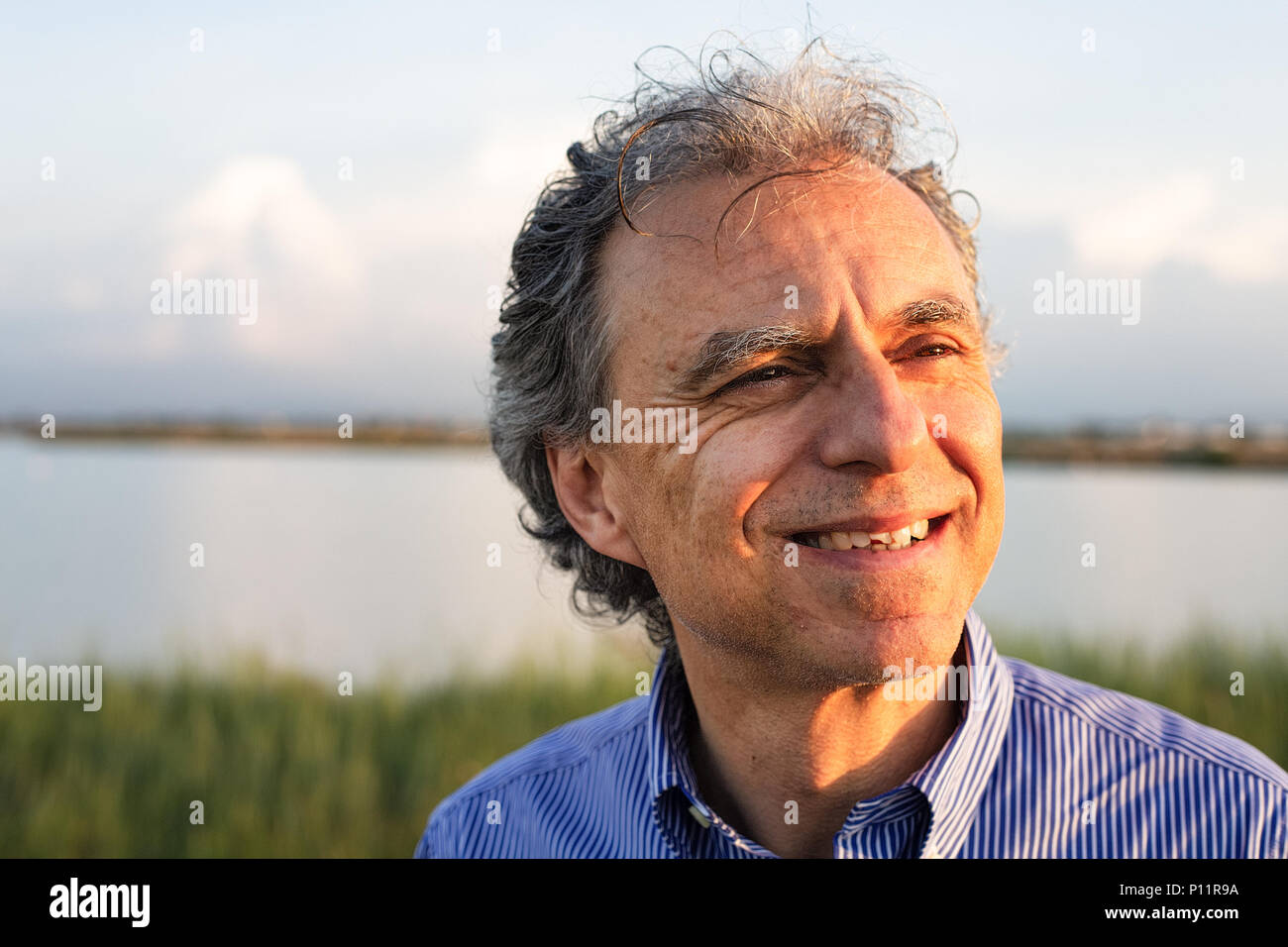 mature man with tanned and aged sagging skin with wrinkles and spots ...