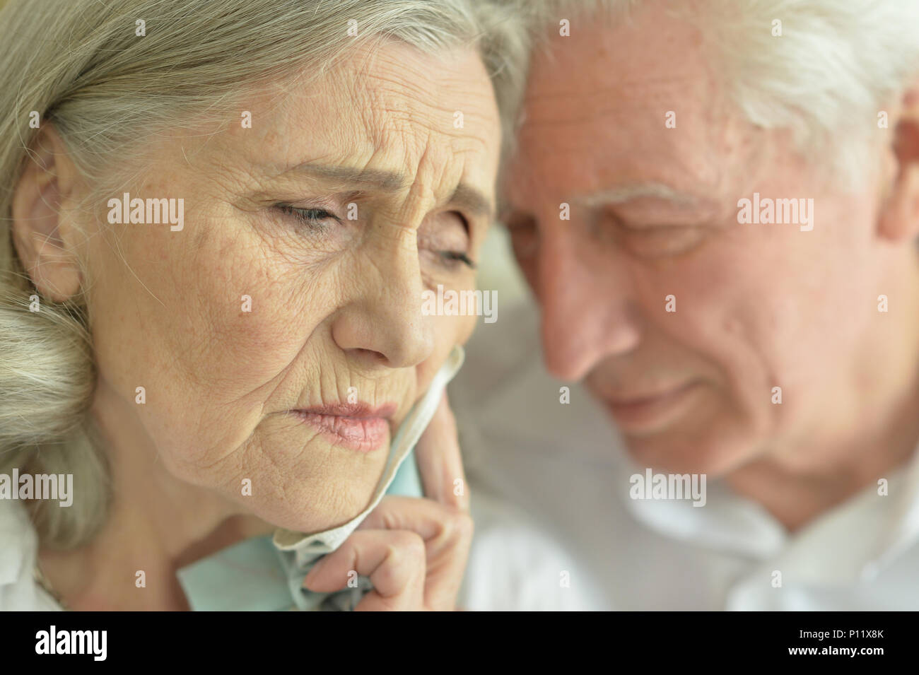 man holding hand on cheek Stock Photo - Alamy