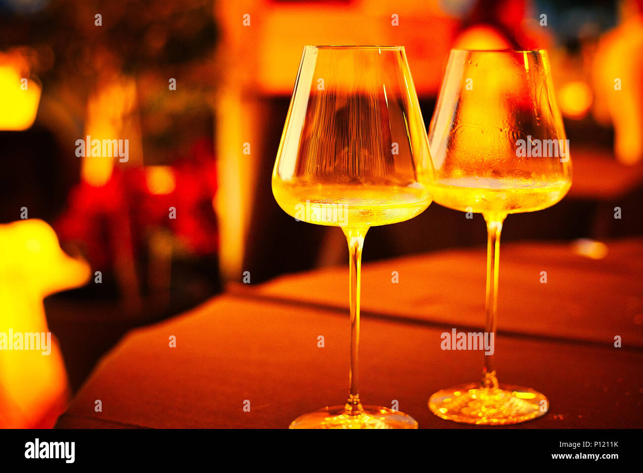 humid white wine goblets on restaurant table Stock Photo - Alamy