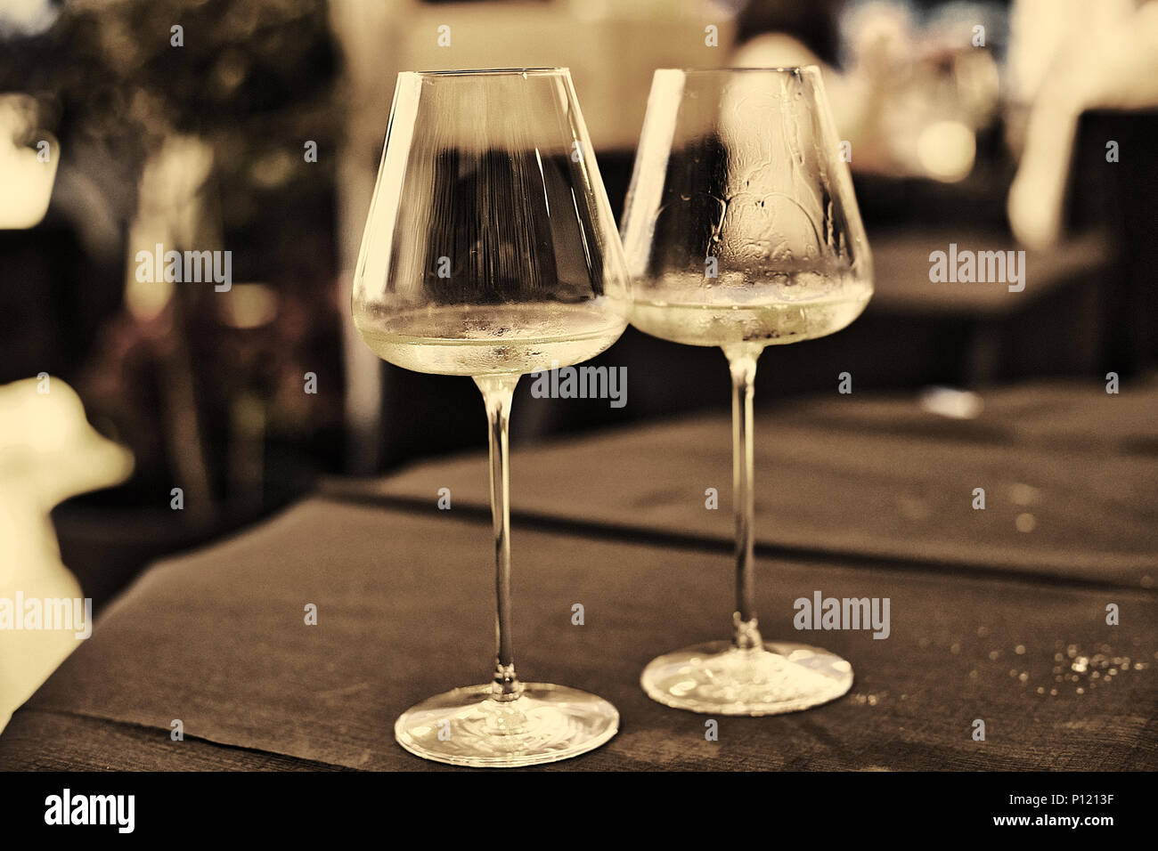 humid white wine goblets on restaurant table Stock Photo - Alamy