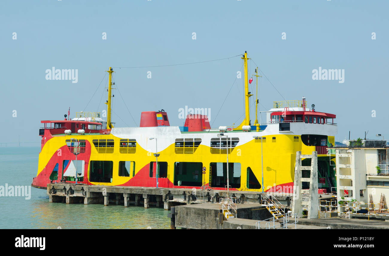 Yellow ferry with mountain and cloudy sky at background in Georgetown ...