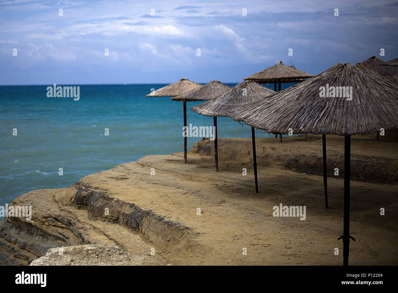 Under construction beach resort with wooden umbrellas which is by the ...