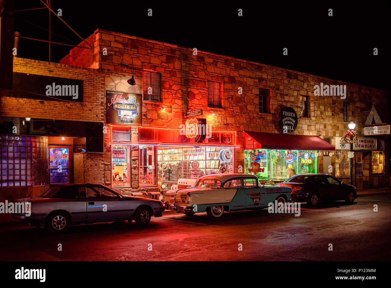 Parks cars at night on the main street of Williams, Arizona at night ...